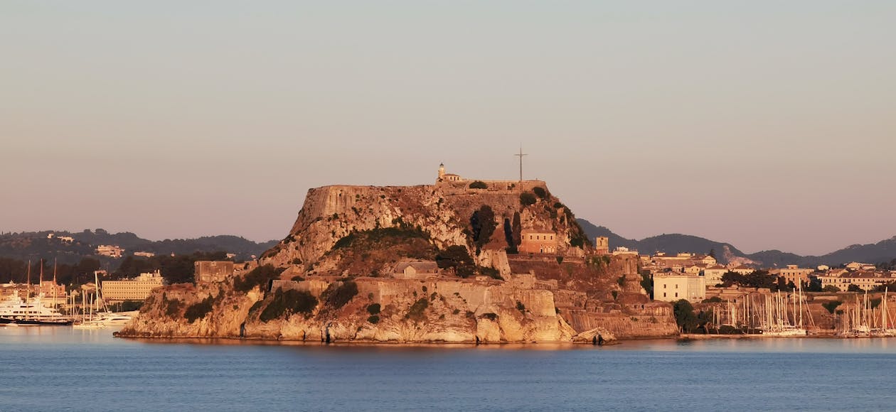 Explore the historic Old Fortress of Corfu, Greece along a stunning seafront view.