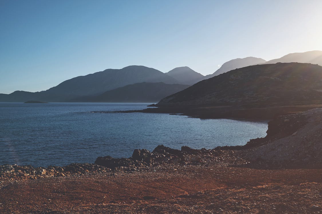 Explore the serene coastline of Ierapetra, Greece, highlighting the striking mountains and calm sea.