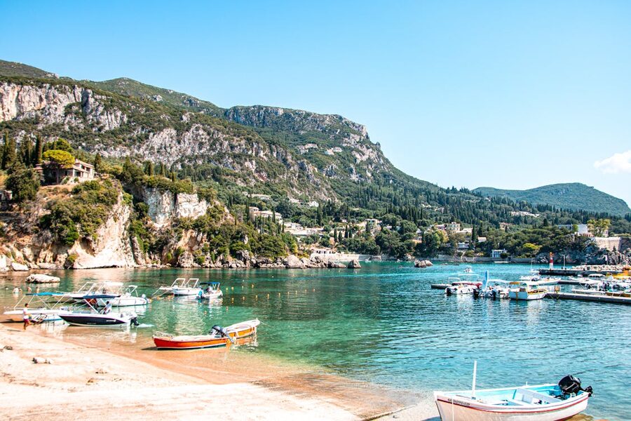 Explore the stunning azure waters and mountainous backdrop of Corfu's coastline in Greece.