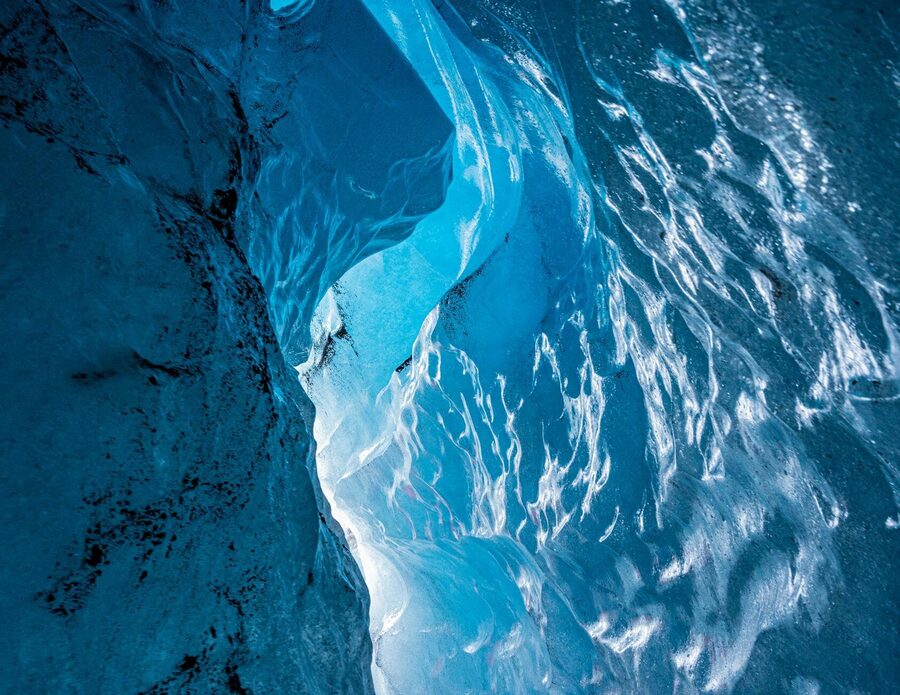 Explore the stunning blue hues of an ice cavern in Iceland, showcasing nature's icy artistry.