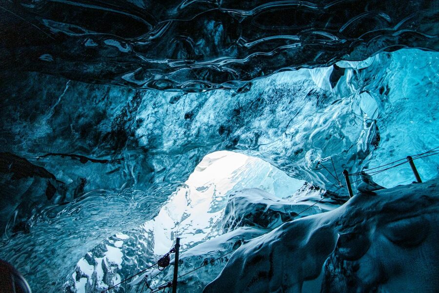 Explore the stunning interior of an Icelandic ice cave with spellbinding blue hues and frozen texture