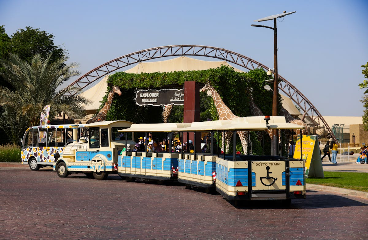 Kids enjoying a mini train ride outside a theme park village