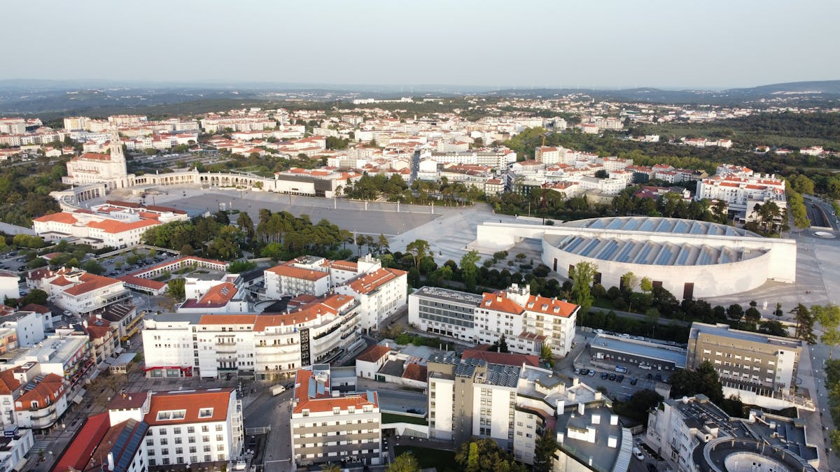 Aerial shot of the Fátima Sanctuary surrounded by the city of Fátima in Portugal