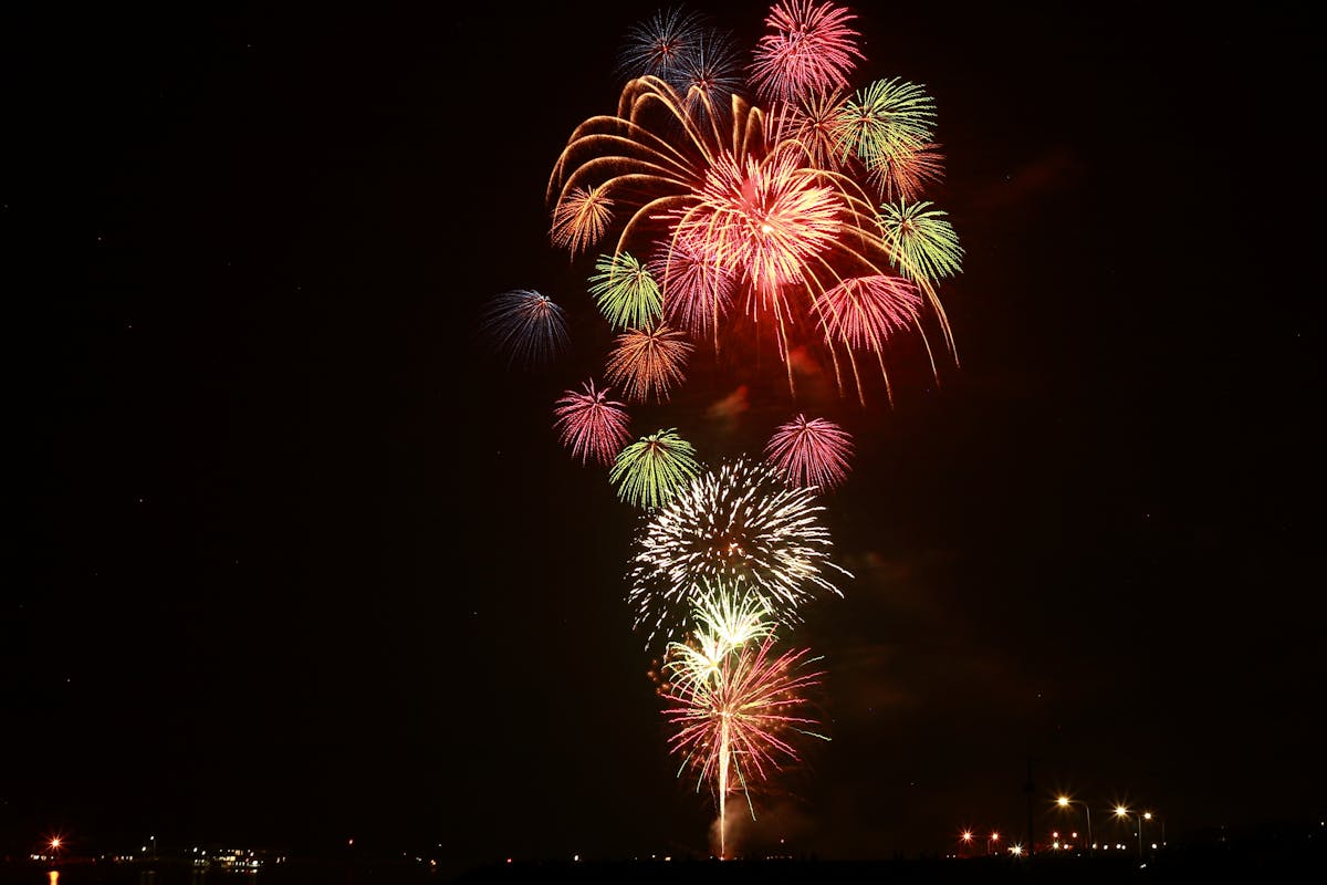 Colorful fireworks lighting up the night sky during a festival celebration