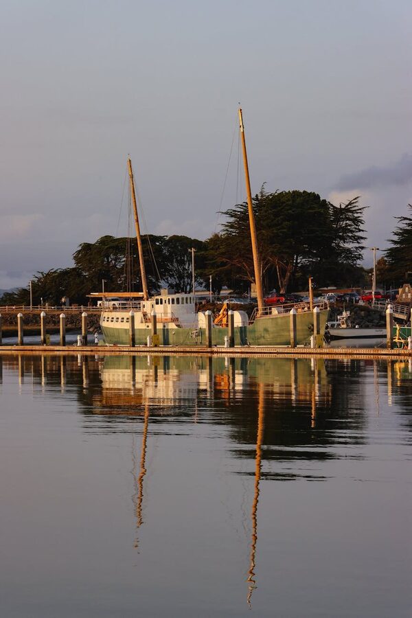 Classic ship docked at Bergen harbor with waterfront buildings