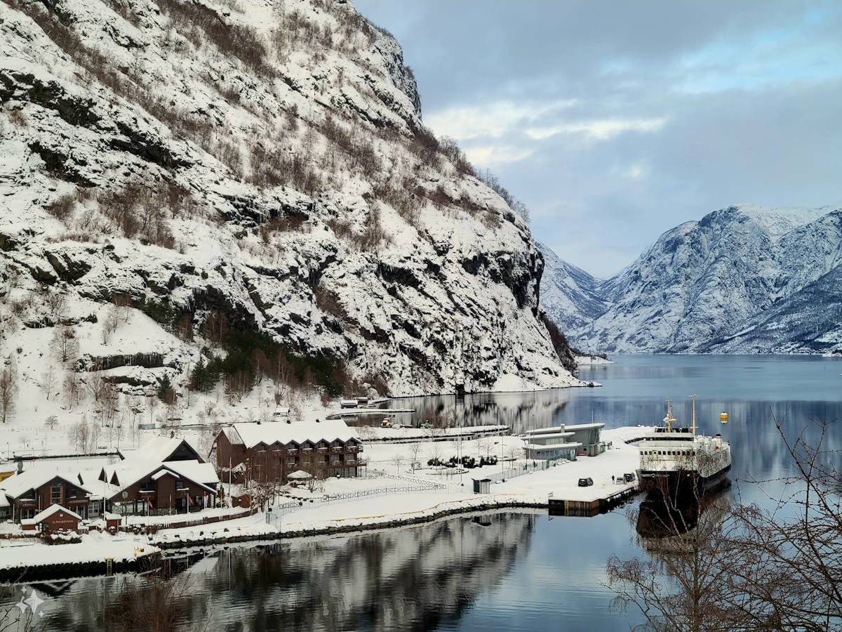 Snow-covered port in Flam Vestland Norway reflecting mountains in winter