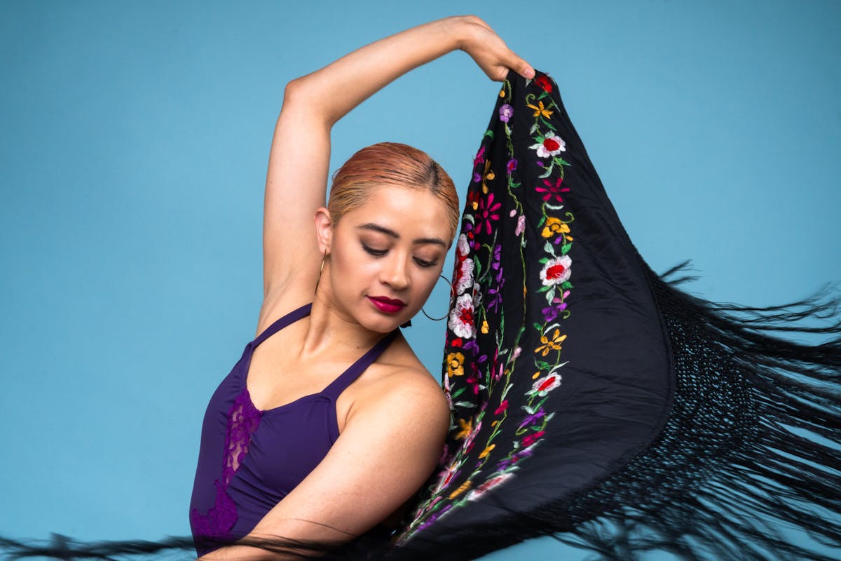 Flamenco dancer posed with a colorful shawl showcasing cultural grace