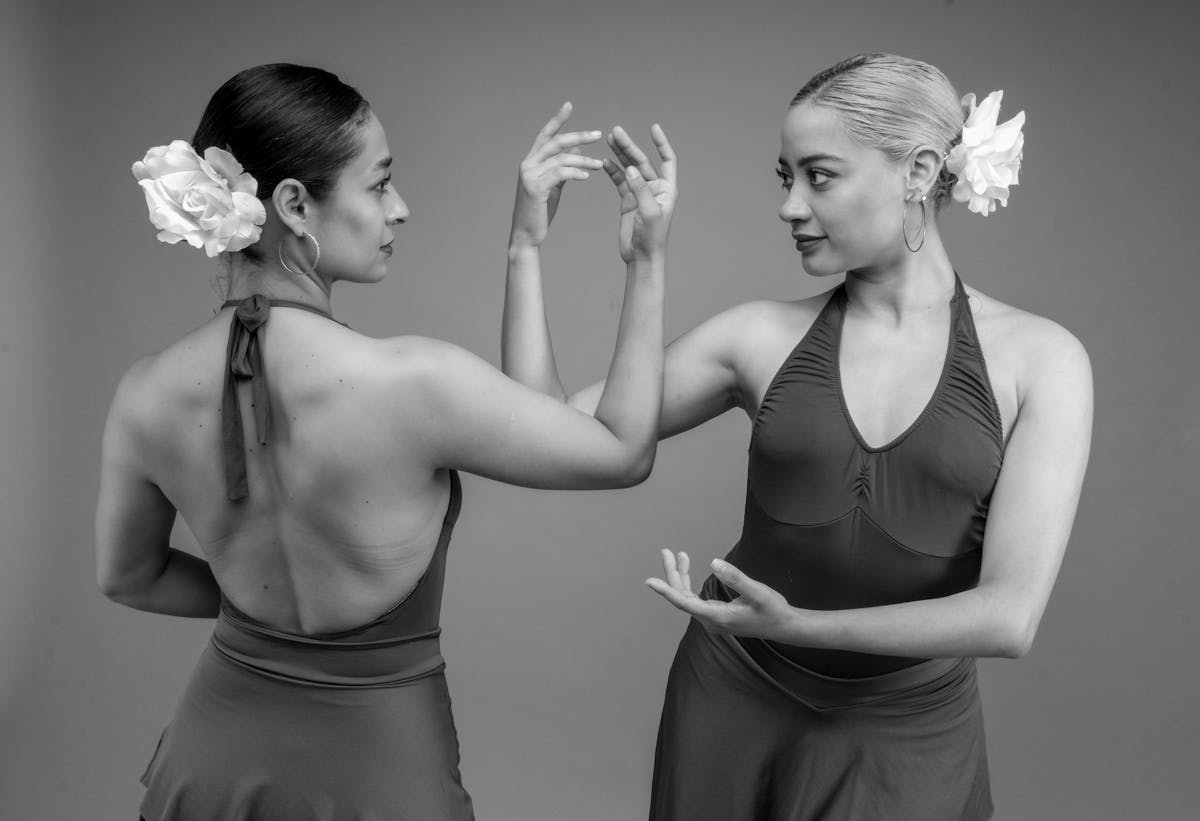 Two female flamenco dancers in graceful poses showcasing Spanish dance culture