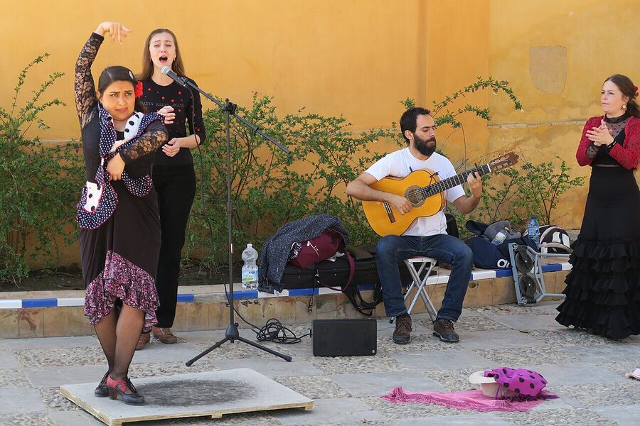 Flamenco dancers and musicians performing on a street in Seville Spain