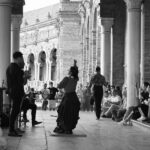 Two flamenco dancers in traditional dresses performing at Plaza de Espana in Seville Spain