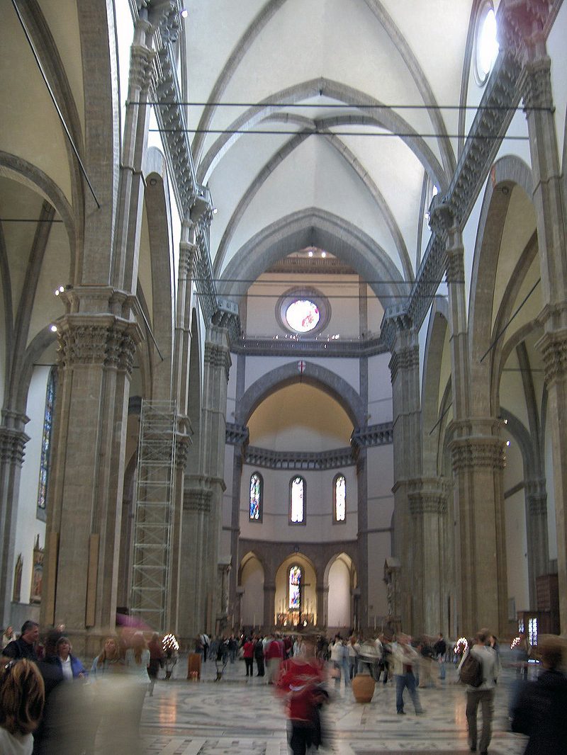 The nave of Florence Cathedral showing the austere Gothic interior with marble floors