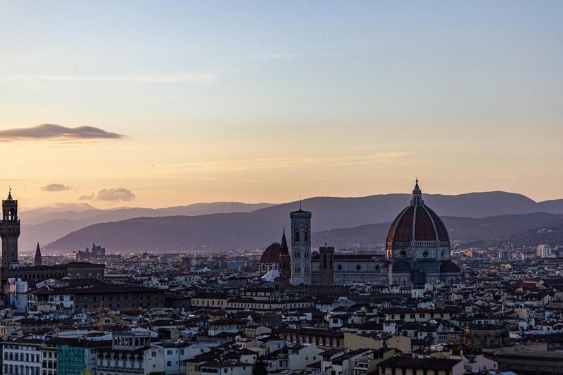 Stunning Florence cityscape at sunset with the iconic Duomo and surrounding mountains