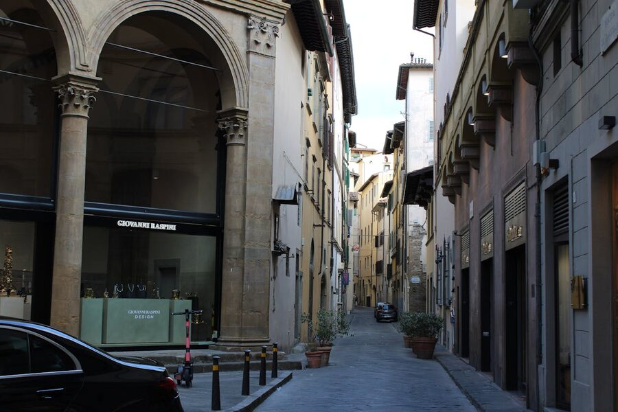 Picturesque narrow cobblestone street in Florence with hanging laundry and traditional architecture