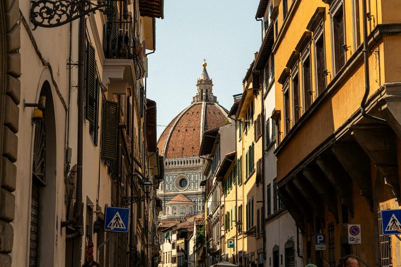 A picturesque street in Florence with a view of the iconic cathedral dome
