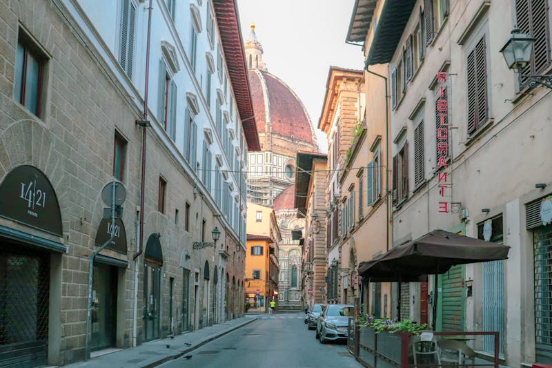 Narrow Florence street with view of the Duomo cathedral dome