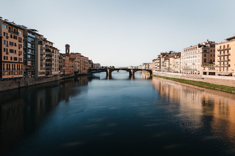 View along the Arno River in Florence showing historic bridges and waterfront buildings