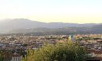 Panoramic view of the Florence skyline with the Cathedral and hills at sunset