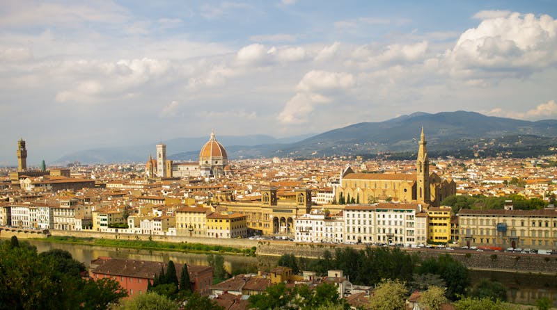 Stunning aerial view of Florence featuring the iconic Duomo and Arno River on a bright summer day