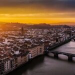 Breathtaking aerial view of Florence at sunset showing the Arno River and Ponte Vecchio bridge