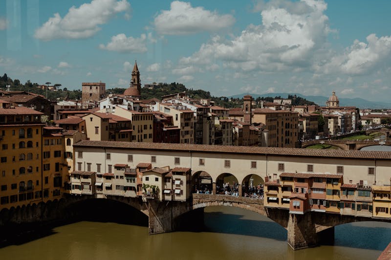 View of Ponte Vecchio and Florence historic skyline under a colorful sky