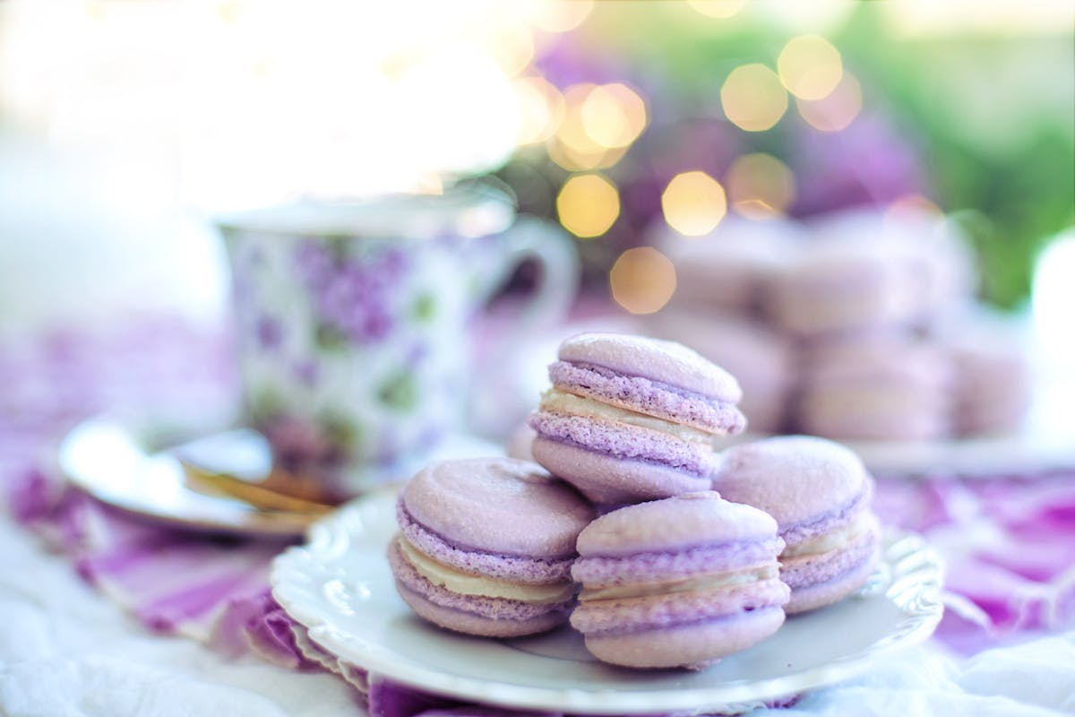 Rows of colorful French macarons at a Paris patisserie