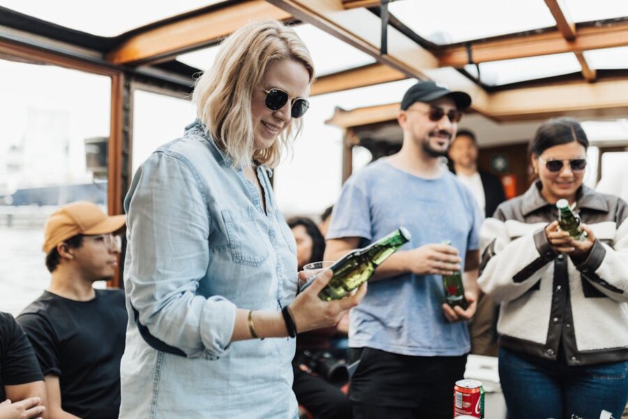 A group of friends having fun on a boat with drinks enjoying leisure time together