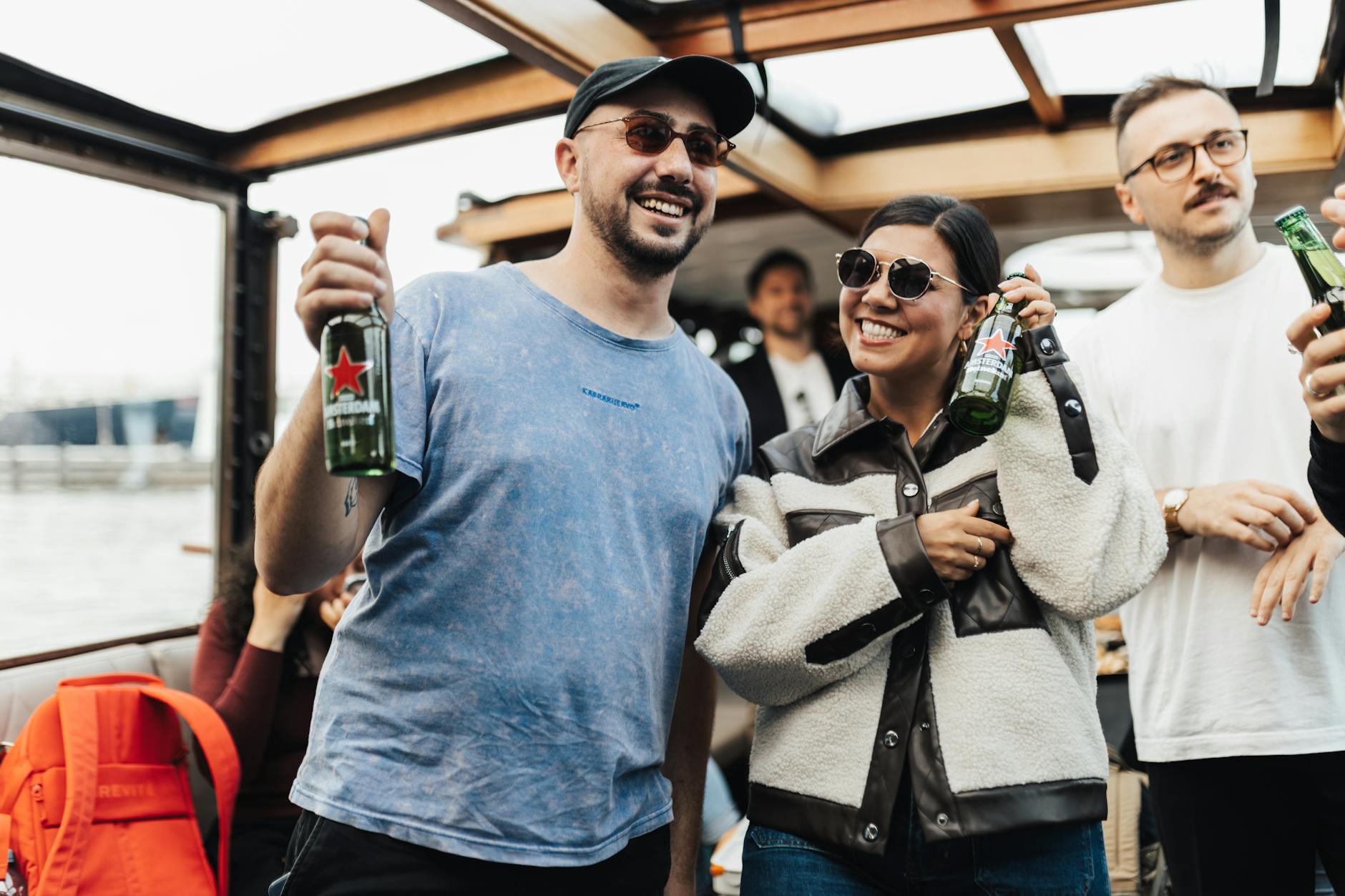 Group of friends laughing and celebrating on a boat cruise