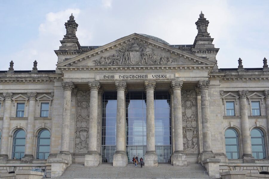 Stone museum building facade with directional signs