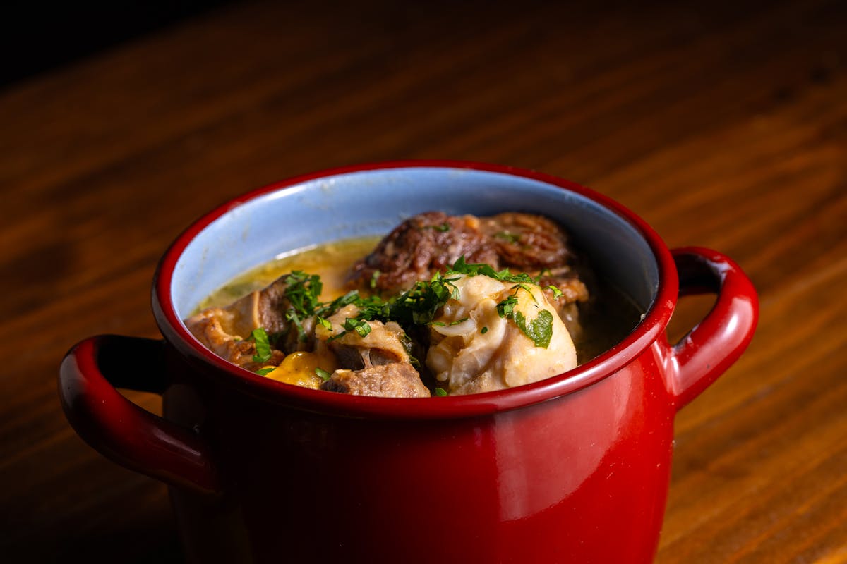 Hearty lamb stew in a rustic red pot