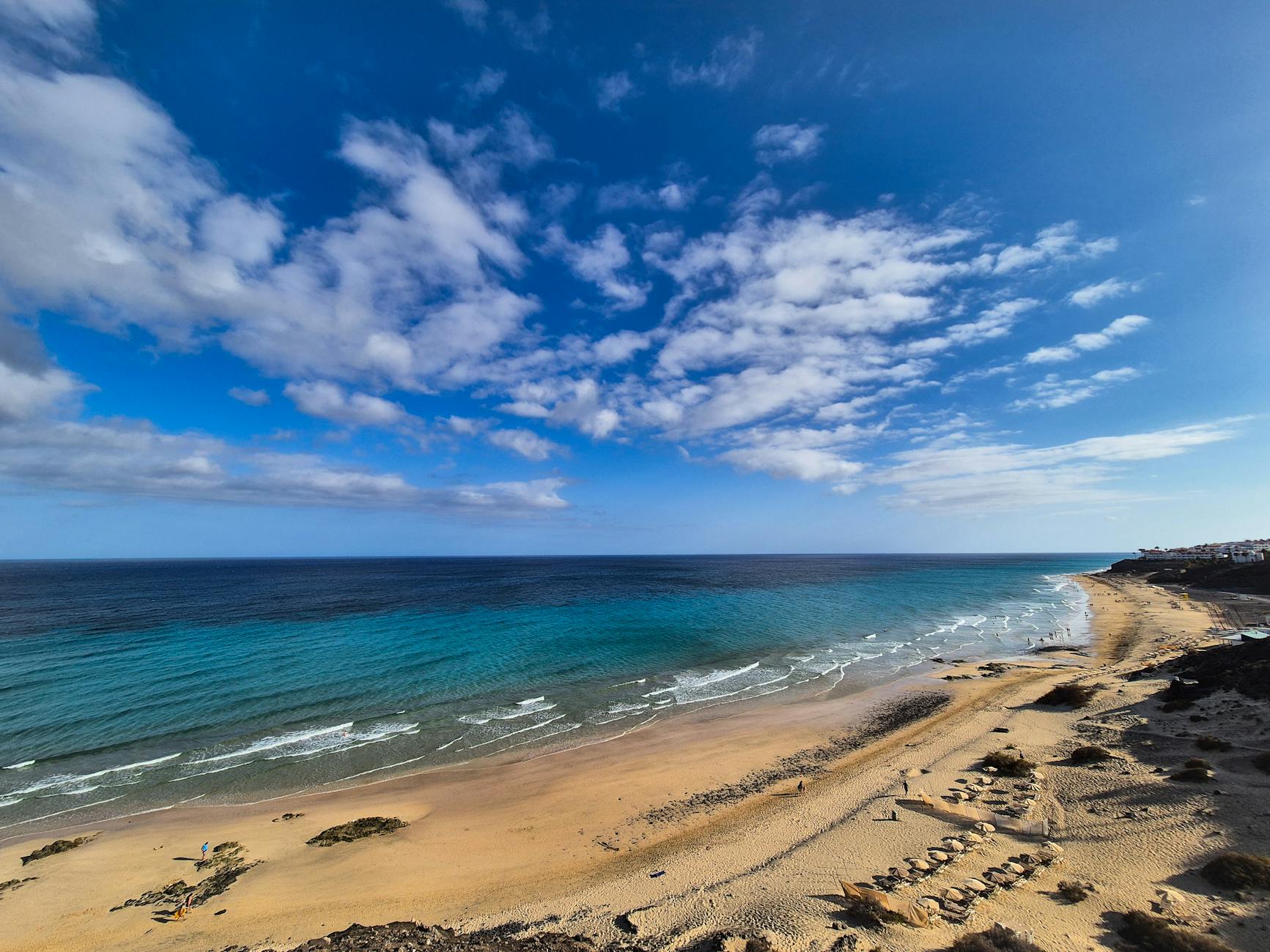 Sandy beach and harbour area in Fuerteventura with boats