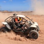 Dune buggy riding through sandy desert terrain in Corralejo Fuerteventura
