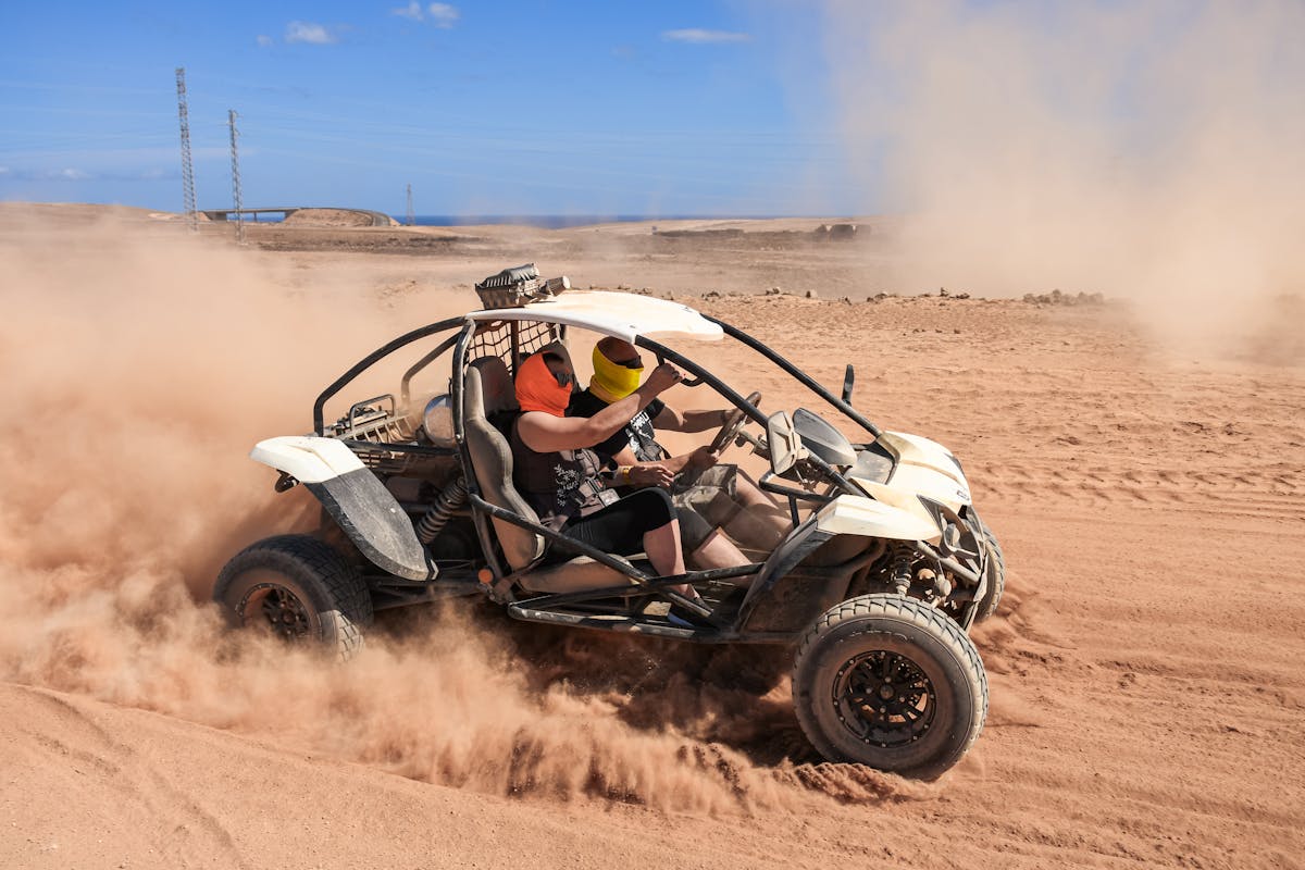 Dune buggy riding through sandy desert terrain in Corralejo Fuerteventura
