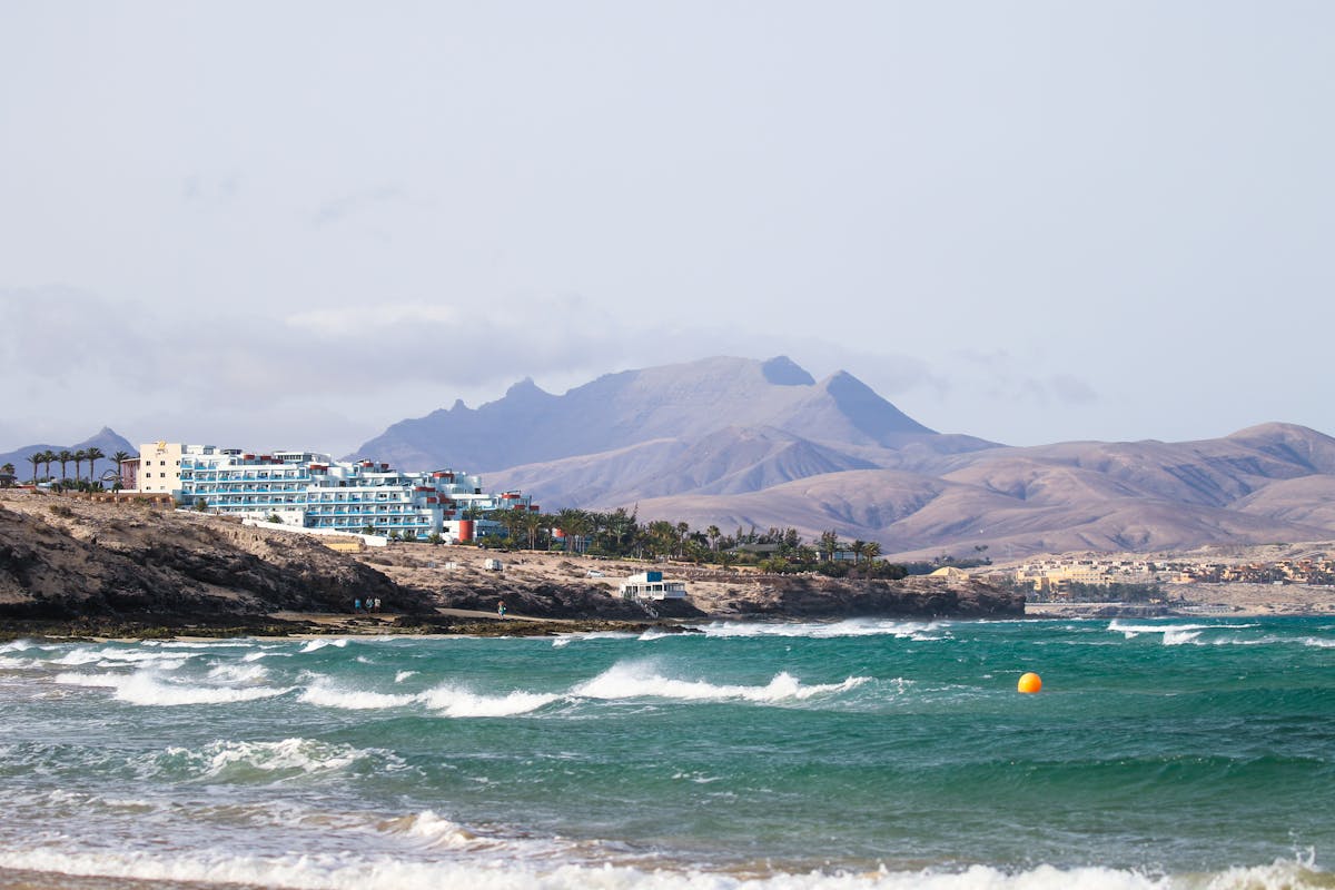 Scenic view of Fuerteventura coastline with waves and volcanic mountains