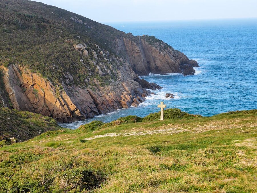 A solitary stone cross on the rugged Galician coast overlooking the Atlantic Ocean