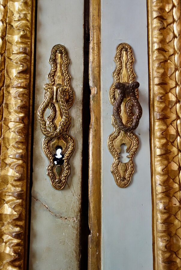 Ornate gilded doorway inside the Galleria Borghese with elaborate carvings and frescoes