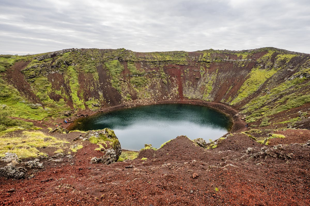 Kerid crater lake with green and red volcanic rock surroundings in Iceland