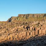 Hexagonal basalt columns at Giants Causeway Northern Ireland with ocean waves