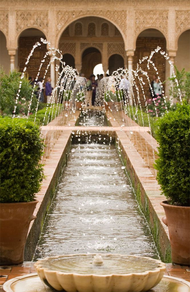 Water fountains arching over a long pool in the Generalife gardens