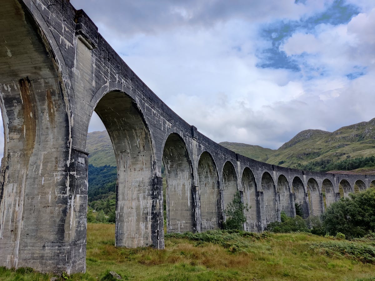 The historic 21-arch Glenfinnan Viaduct stretching across the Highland valley
