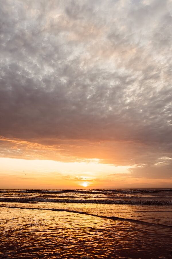 Sunset over rugged coastal landscape in Flakstad Lofoten Norway