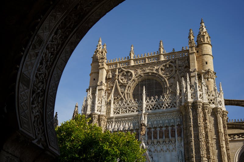 Ornate Gothic facade of Seville Cathedral showing detailed stone carvings and spires