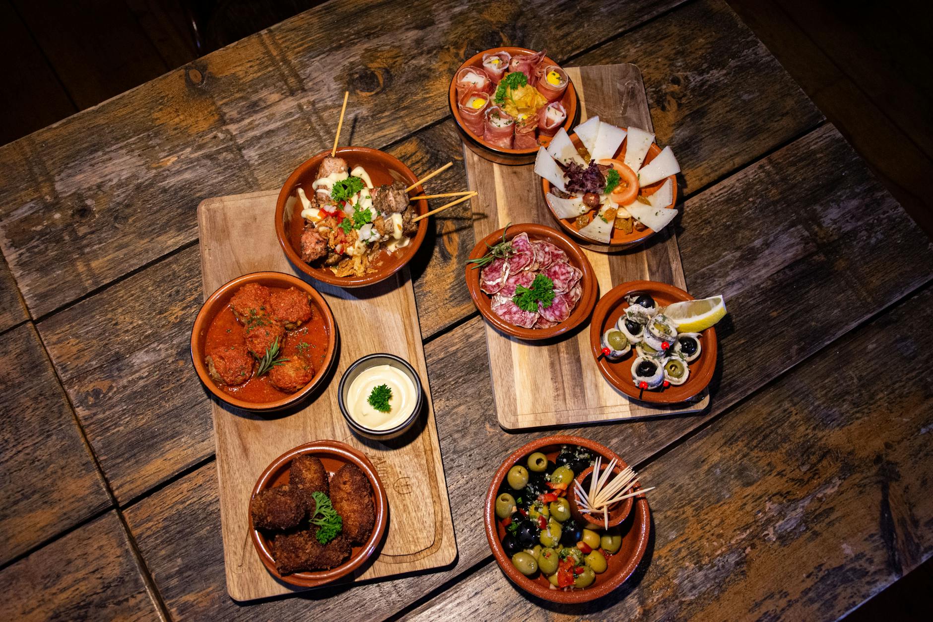 Gourmet tapas variety laid out on a wooden table