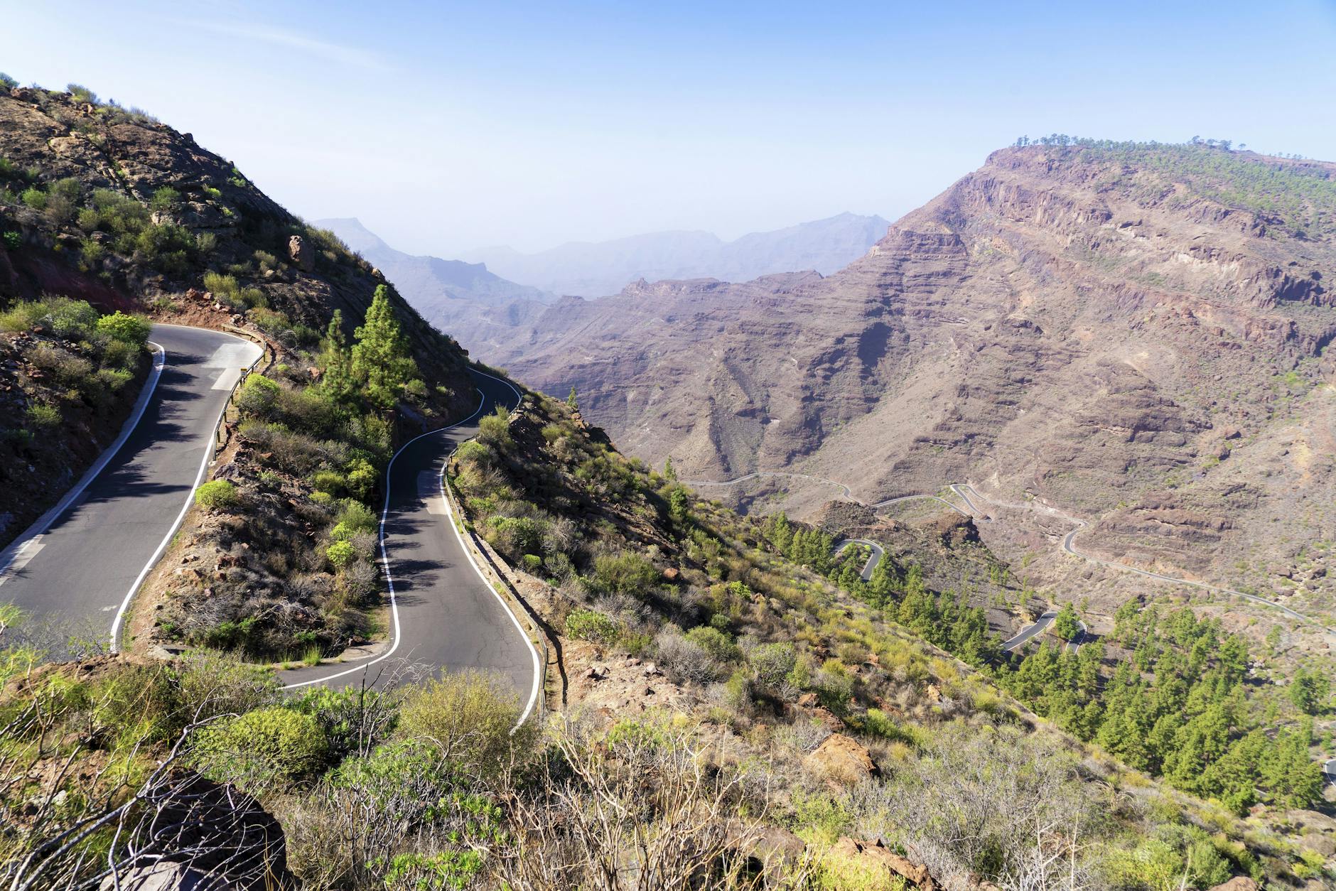Aerial view of curvy mountain road through Gran Canaria highlands