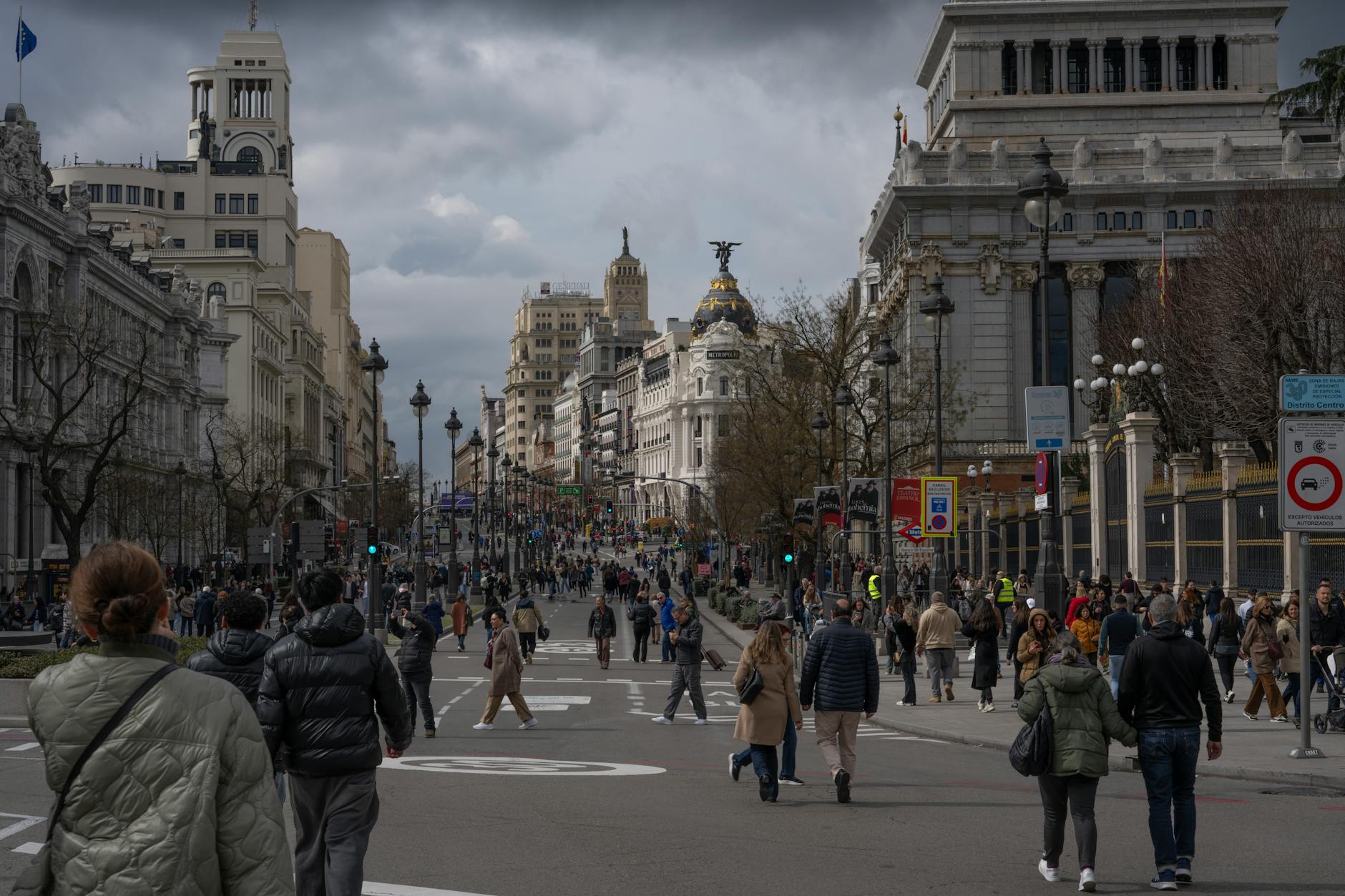 Busy street scene in Madrid city center on Gran Via with iconic architecture