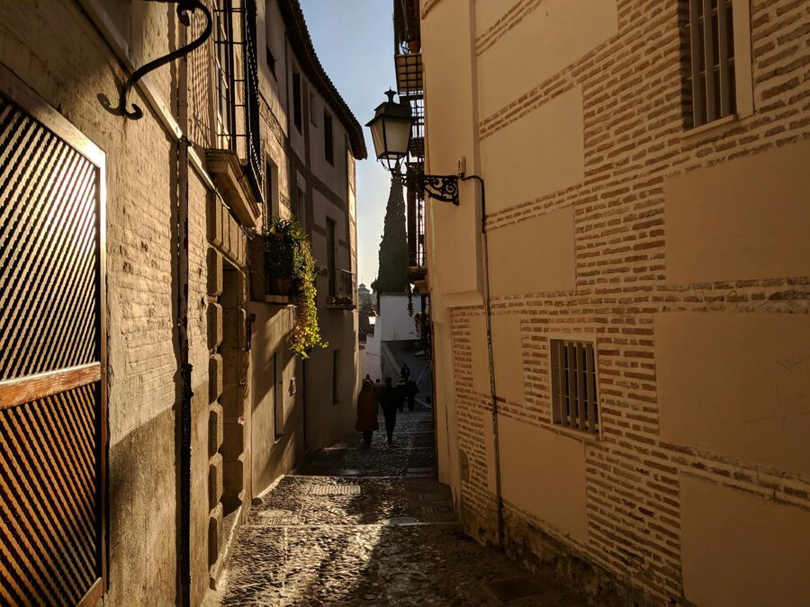 Charming cobblestone streets of Granada Spain at dusk with warm lighting