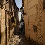 Cobblestone streets of Granada Spain at dusk with warm evening light