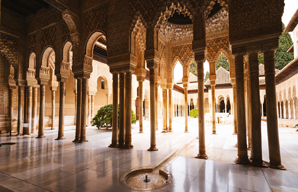 Ornate Islamic arches and columns inside the Alhambra palace courtyard in Granada Spain