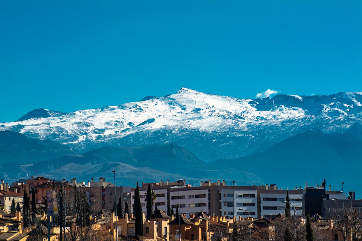Snow-capped Sierra Nevada mountains visible behind the Granada city skyline in Andalusia Spain