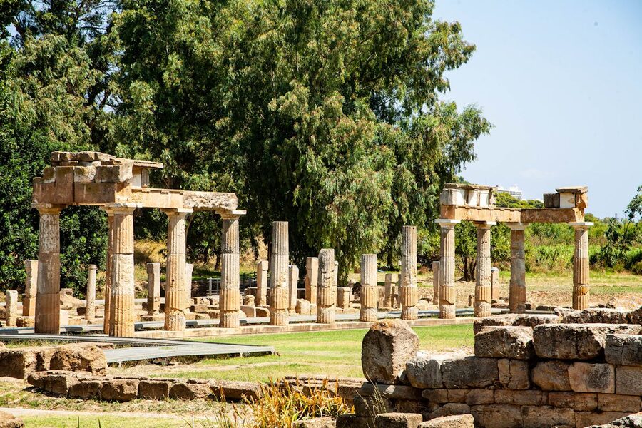 Well-preserved classical Greek ruins under blue sky