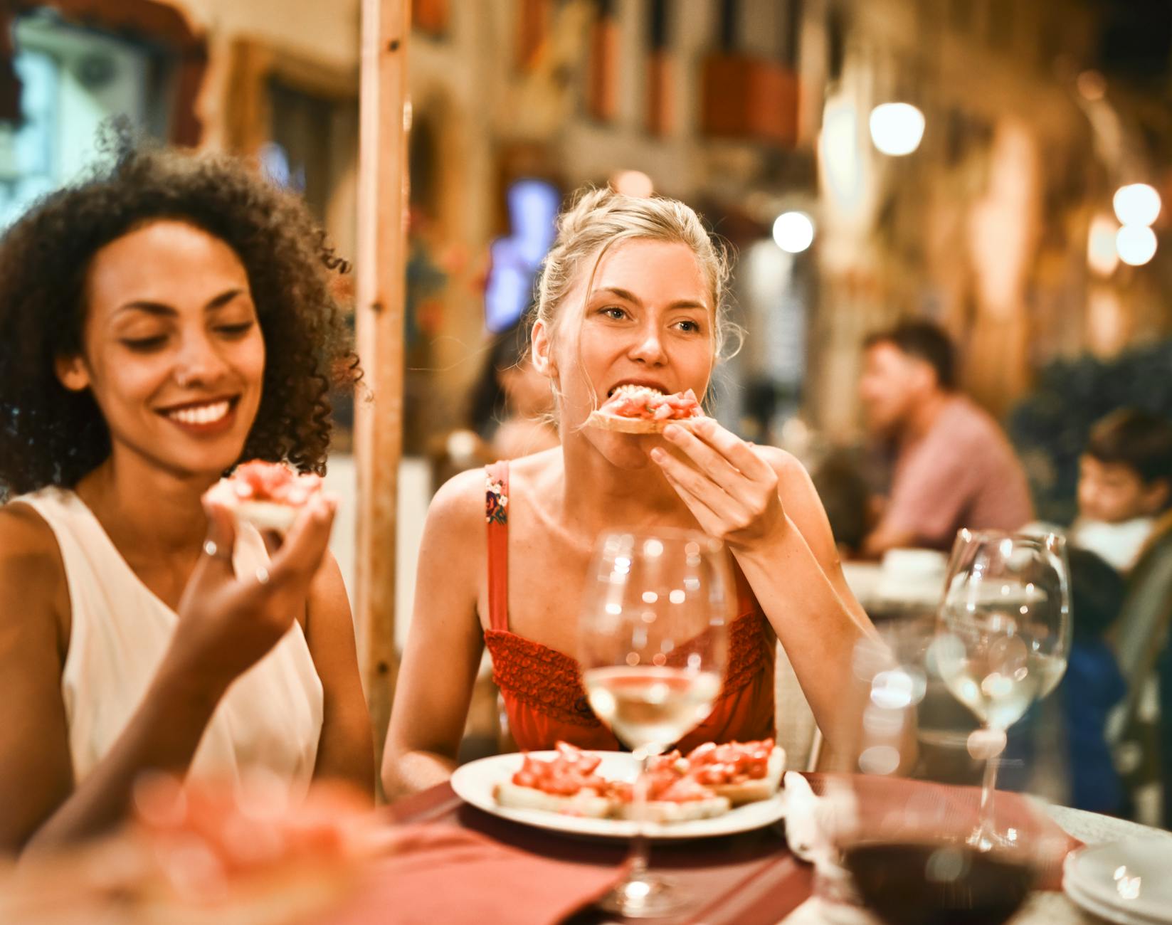 A group of travelers enjoying pintxos and wine during a Bilbao food tour